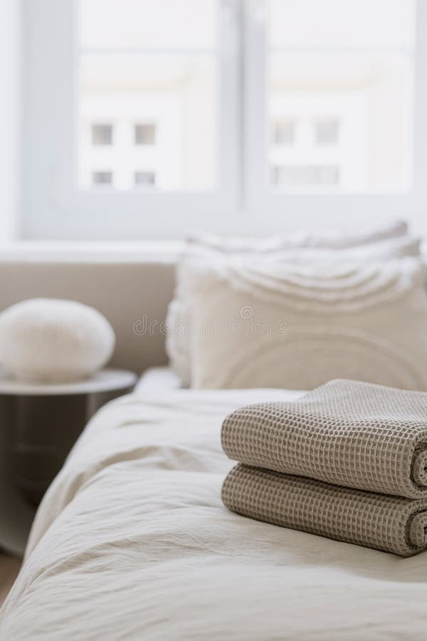 Selective Focus on Stack of Fresh Soft Beige Towels on Comfortable Bed ...