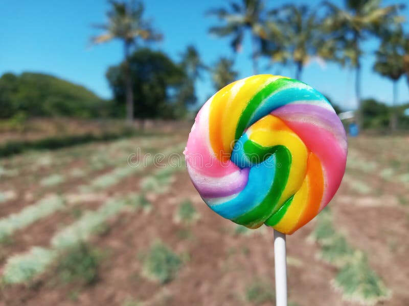 Selective Focus of Swirl Stick Rainbow Candy with Blurred Agriculture ...