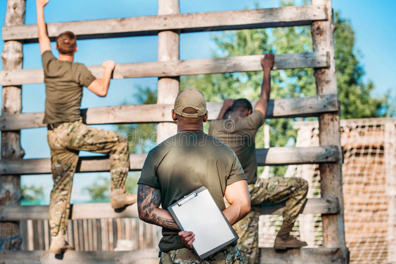 Selective Focus of Tactical Instructor with Notepad Examining ...