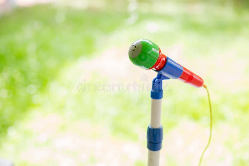 Selective Focus To Colorfull Toy Microphone on Blurry Green Background ...