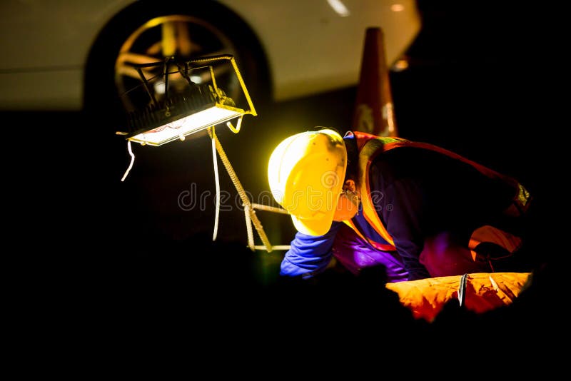Selective Focus To Spotlight and Construction Worker is Working at ...