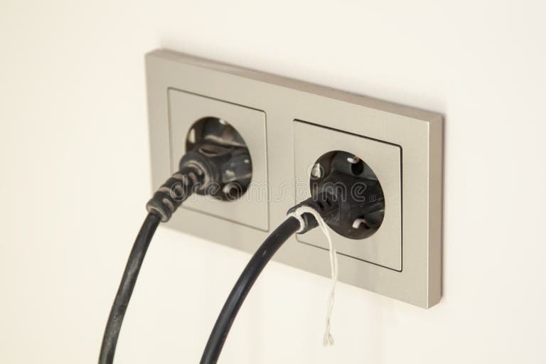 Selective Focus of Two Black Plugs are Plugged into a Double Electrical ...