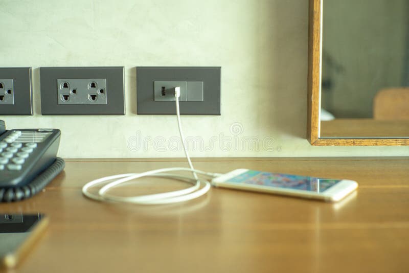 Selective Focus on Wall Electrical Outlet with Charger of Mobile Phone ...