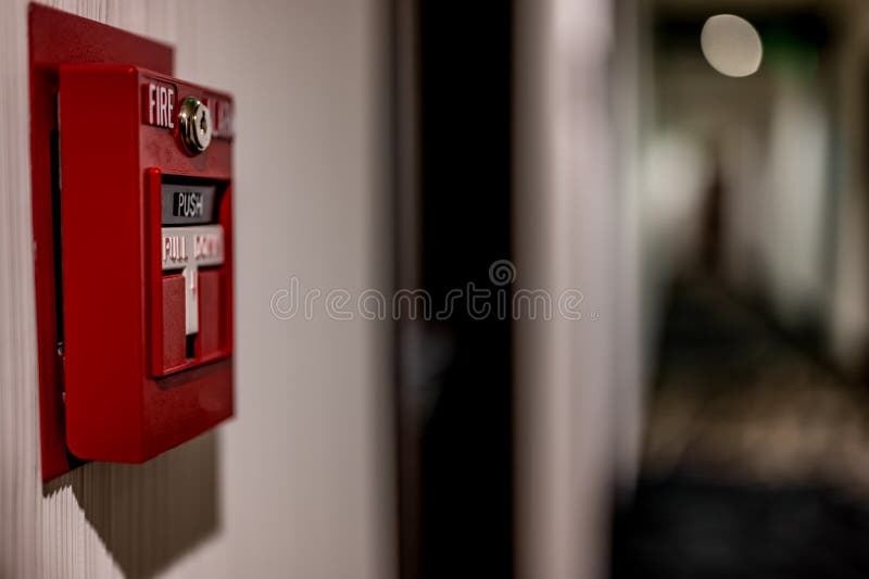 Selective Focus on a Wall Mounted Fire Alarm Switch in a Empty Hallway ...