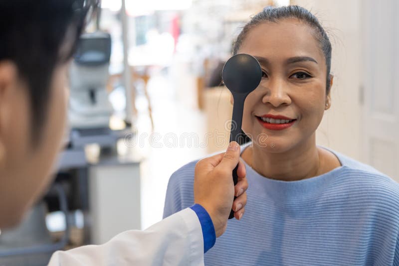 Selective Focus at Screen of Optometry Equipment. while Optometrist ...