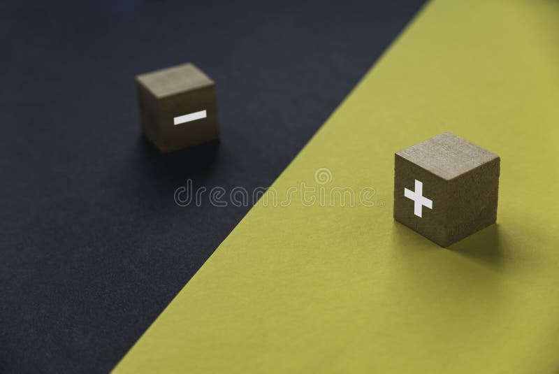 Selective Focus of Wooden Cube with a Negative and Positive Symbol on a ...