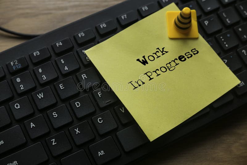 Selective Focus of Yellow Safety Cone and Yellow Sticky Note Written ...