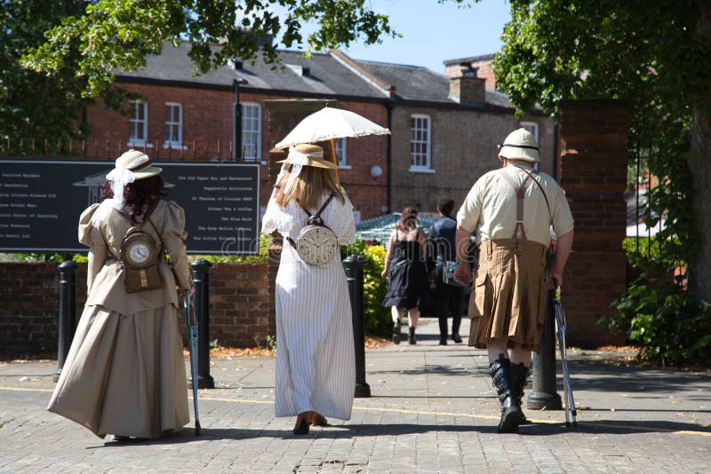 Selective of People in Traditional Dresses and Clock Backpacks Stock ...