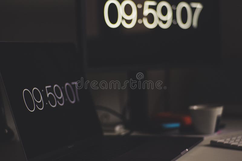 Selective Shot of a Black Laptop with Time Showing 09:59:07 on Its ...