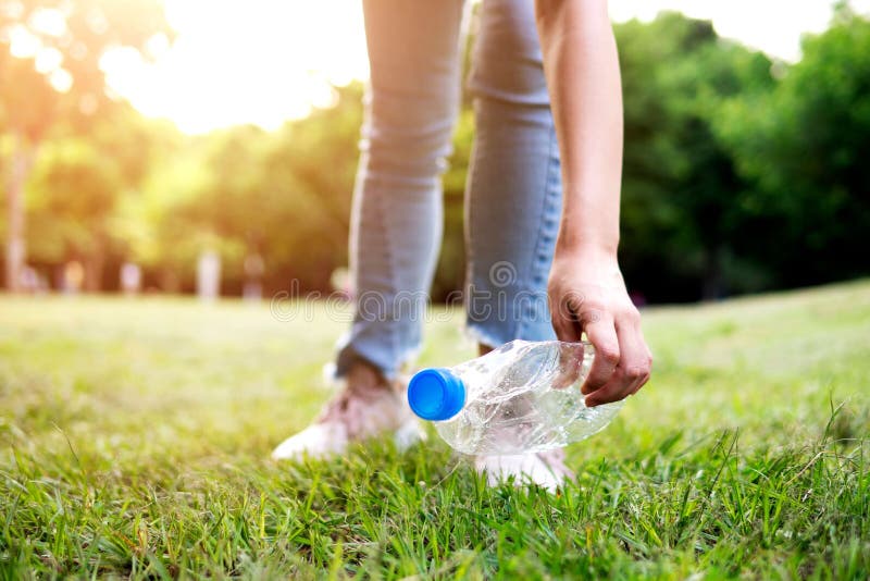 Selective Shot of a Female Hand, Picking a Plastic Garbage Bottle from ...