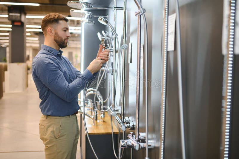 Selects a Shower Faucet. Man Chooses a Products in a Sanitary Ware ...
