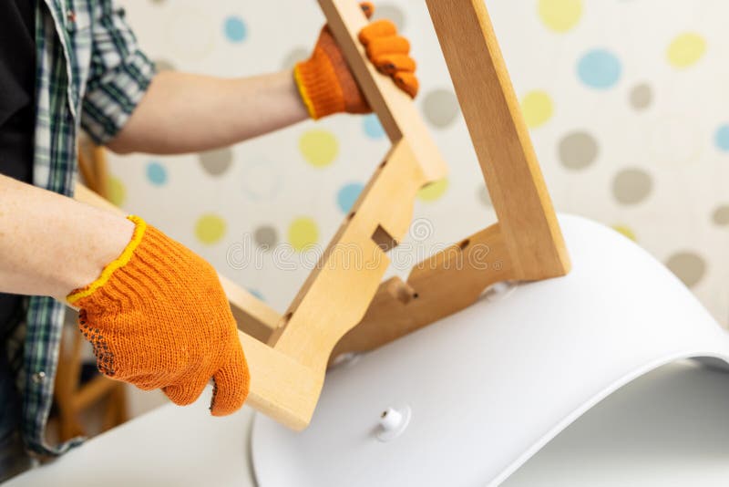 Self-assembly Furniture Concept. the Young Man Himself Assembling ...
