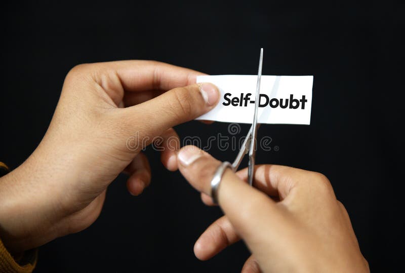 Self-Doubt Concept Background with Hand Cutting the Text Paper ...