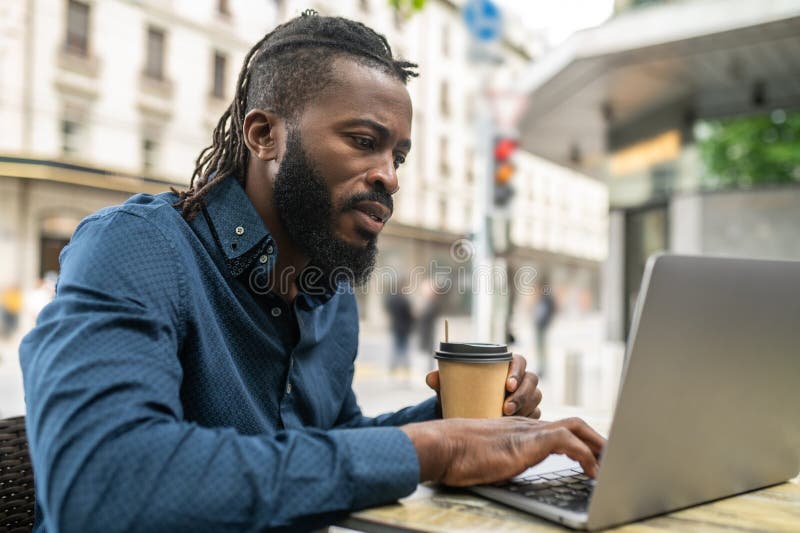 Dark-skinned Young Man Working in a Cafe Outdoors Stock Photo - Image ...