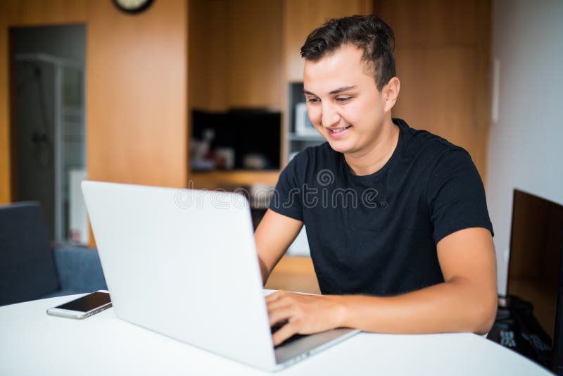 Self Employed Man with Smile Working from Home on Laptop Stock Photo ...