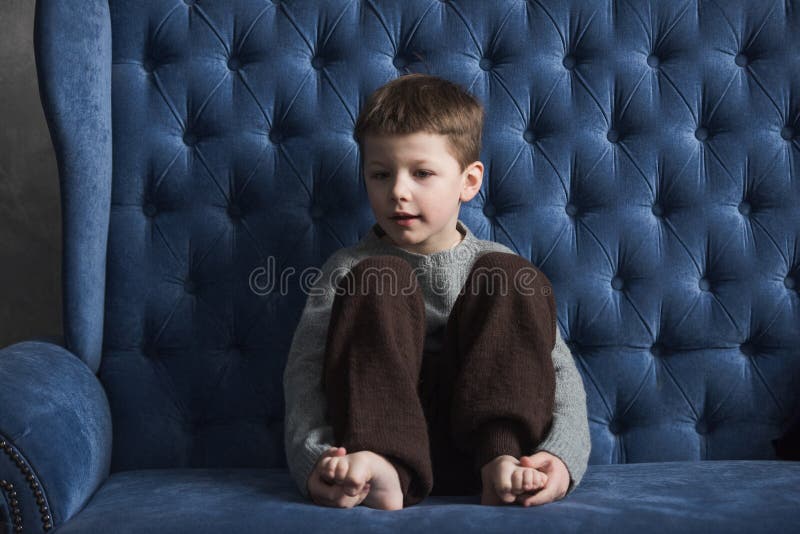 During Self-isolation a Boy Sits on Blue Sofa Stock Image - Image of ...