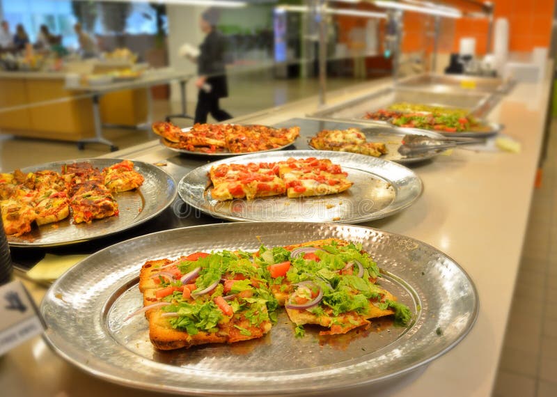 Self Serve Pizza at a Cafeteria with Diners and Waiter Stock Photo ...