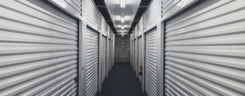 Self Storage Unit Doors on Each Side of an Indoor Hallway. Stock Image ...