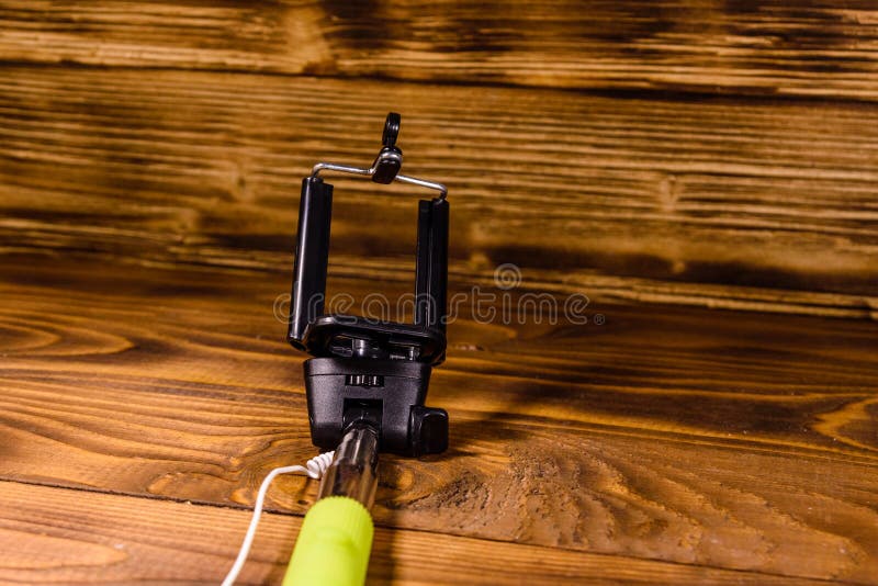 Selfie Stick with Adjustable Clamp on a Wooden Table Stock Photo ...