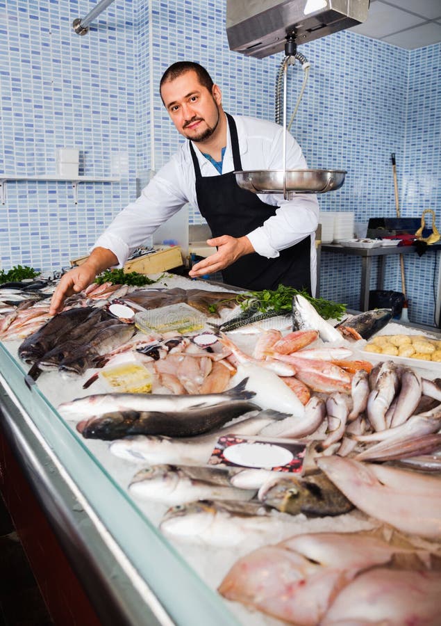 Seller in Black Apron Shows Fish Counter Stock Image - Image of carp ...