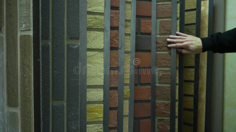 The Seller of Building Materials Runs His Hand Over Samples of Facing ...