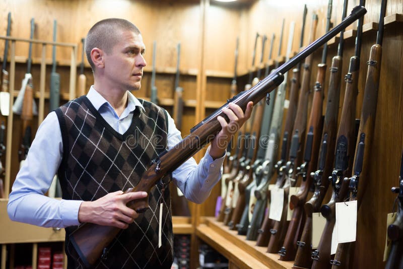 Seller Demonstrates a Combat Winchester in Gun Store Stock Photo ...