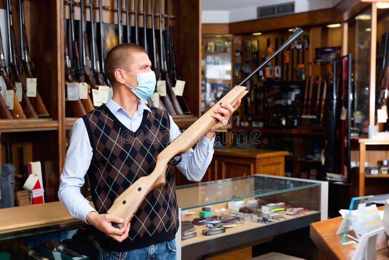 Seller Demonstrates a Combat Winchester in Gun Store Stock Photo ...