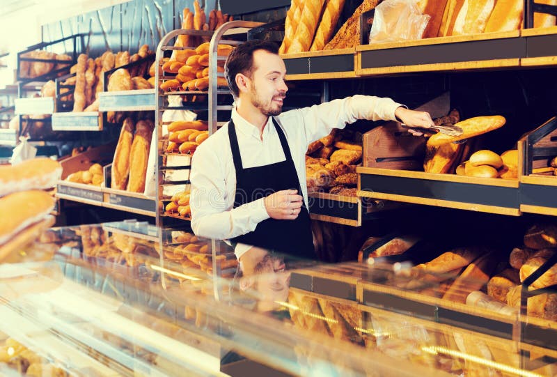 Seller Offering Fresh Loaf of Bread Stock Photo - Image of displayed ...