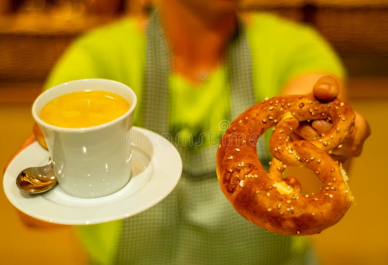 Seller Offers a Coffee and a Pretzel for Breakfast Stock Image - Image ...