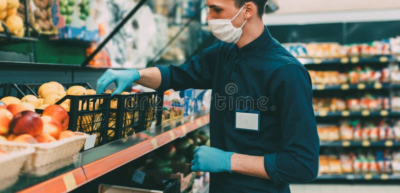 Seller in a Protective Mask Standing in Front of the Counter with Fruit ...