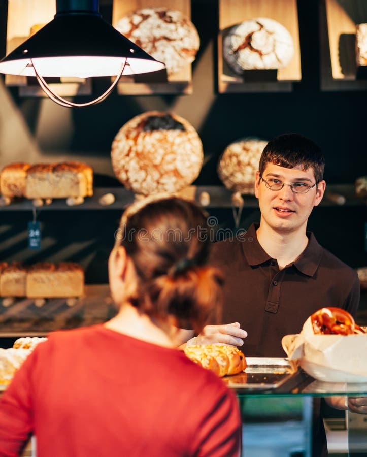 Salesman in a bakery stock photo. Image of sale, eating - 62349456