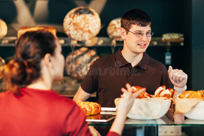 Salesman in a bakery stock photo. Image of sale, eating - 62349456