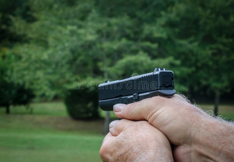 Hand gun being aimed stock photo. Image of firearm, hammer - 1338022