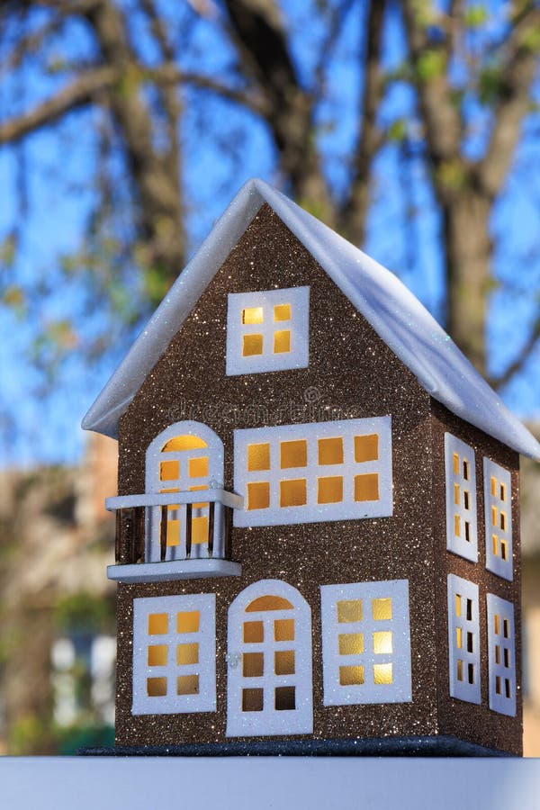 On a Semi-blurred Background of Trees, a Brown House with Yellow Light ...
