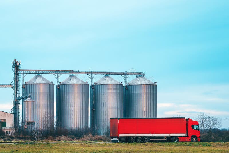 Semi-truck with Red Trailer in Front of Agricultural Grain Processing ...