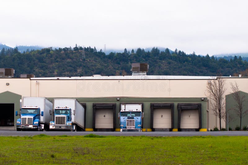 Semi Trucks Blue Trailers Loading Unloading Cargo in Warehouse B Stock ...