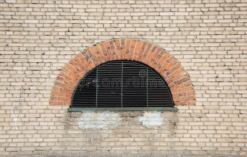 Semicircular Barred Ventilation Window in a White Brick Wall Stock ...