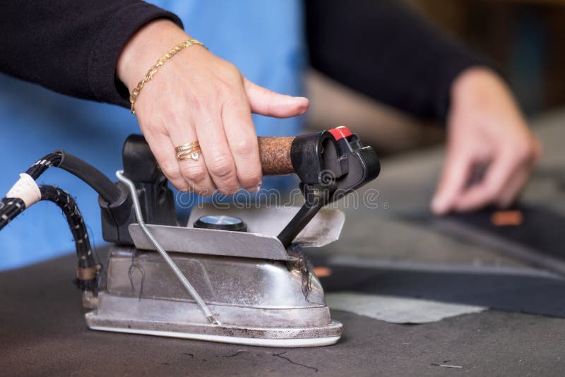 Semstress Ironing the Fabric. Seamstress Irons Fabirc in a Sewing ...