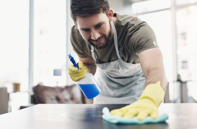 Send those Germs Packing. a Young Man Disinfecting a Table at Home ...