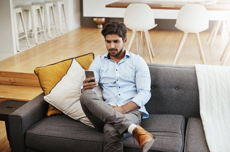 Sending and Receiving Texts. a Handsome Young Man Sending a Text while ... Sending and Receiving Texts. a Handsome Young Man Sending a Text while ...