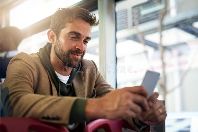Sending a Text while on the Bus. a Handsome Young Man Sending a Text ...