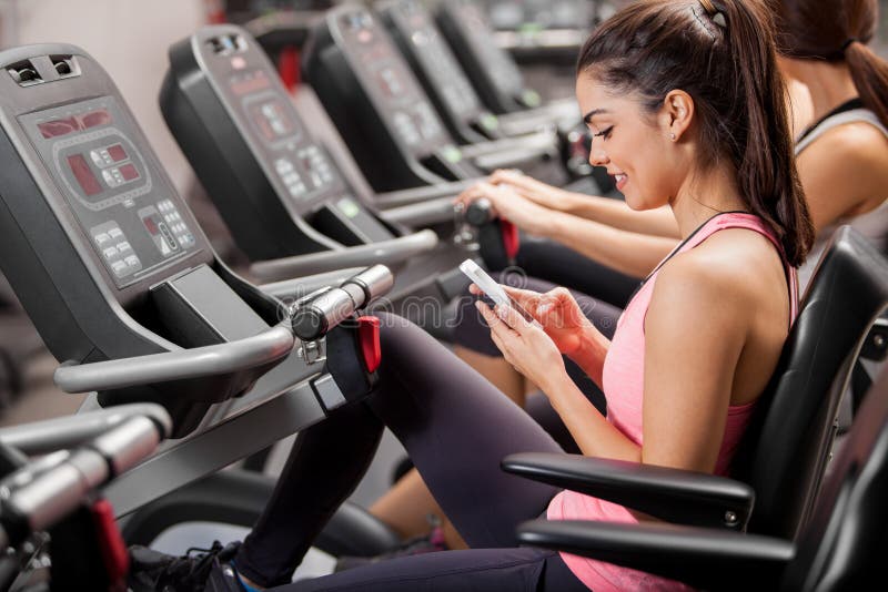 Sending a Text during Gym Class Stock Photo - Image of female, machine ...
