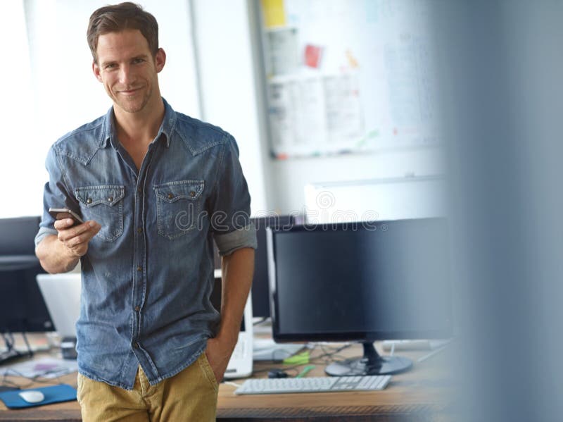 Sending a Text from Work. a Young Man Reading His Text Messages while ...