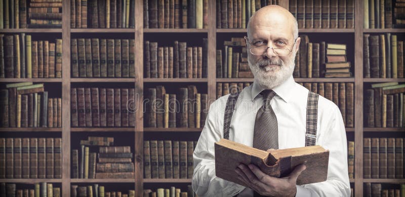 Academic Professor in the Library Holding a Book Stock Photo - Image of ...