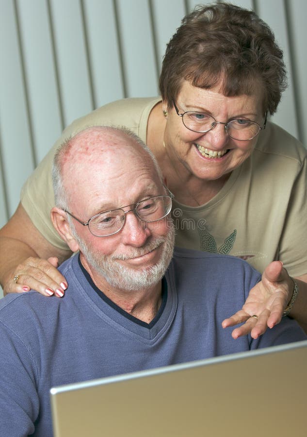 Mature couple using laptop stock photo. Image of laughing - 2241010