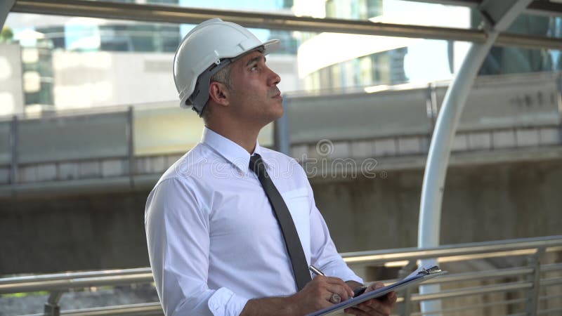 Senior Architect Checking List Construction Site with Clipboard ...