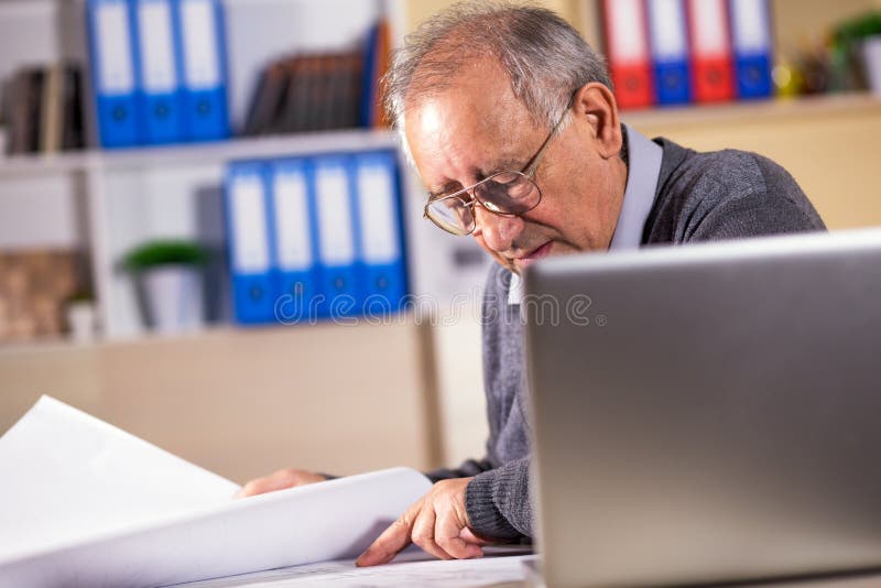 Senior Architect Working on Construction Blueprint in Office Stock ...