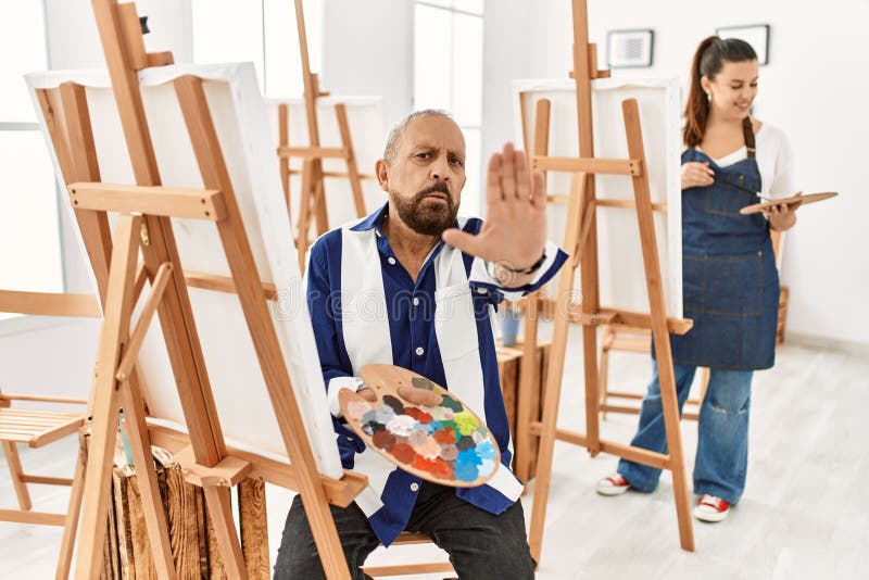 Senior Artist Man at Art Studio Doing Stop Sing with Palm of the Hand ...
