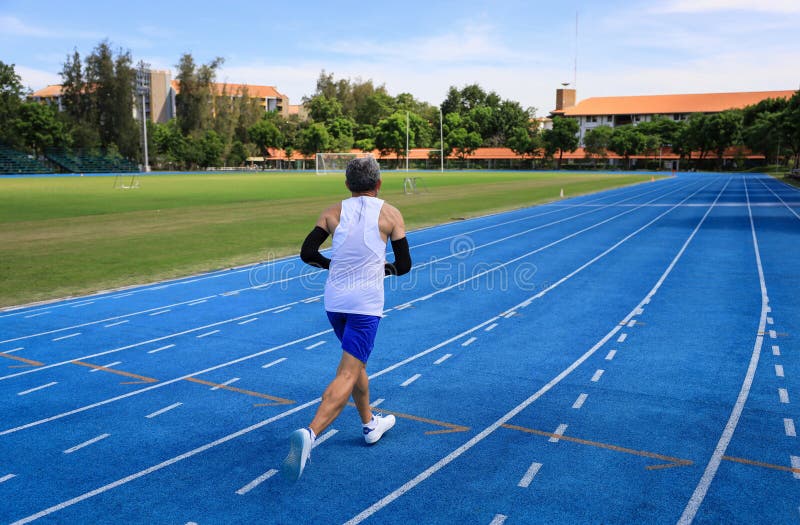 Senior Asian Athlete is Practicing Running in the Professional Blue ...