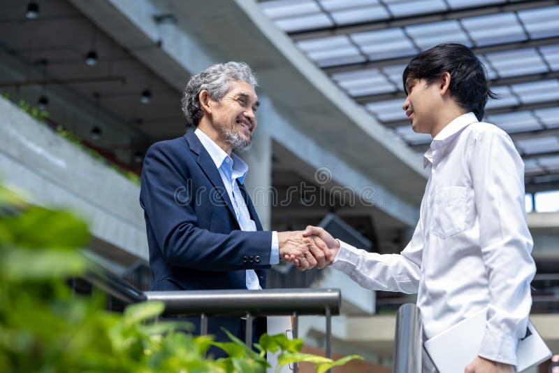 Senior Asian Executive Manager is Handshaking with the New Trainee ...